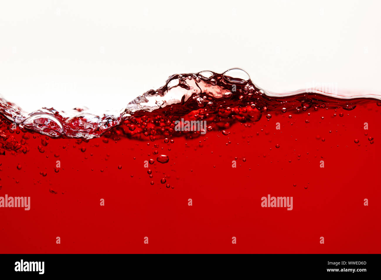 red bright liquid with splash and bubbles isolated on white Stock Photo ...