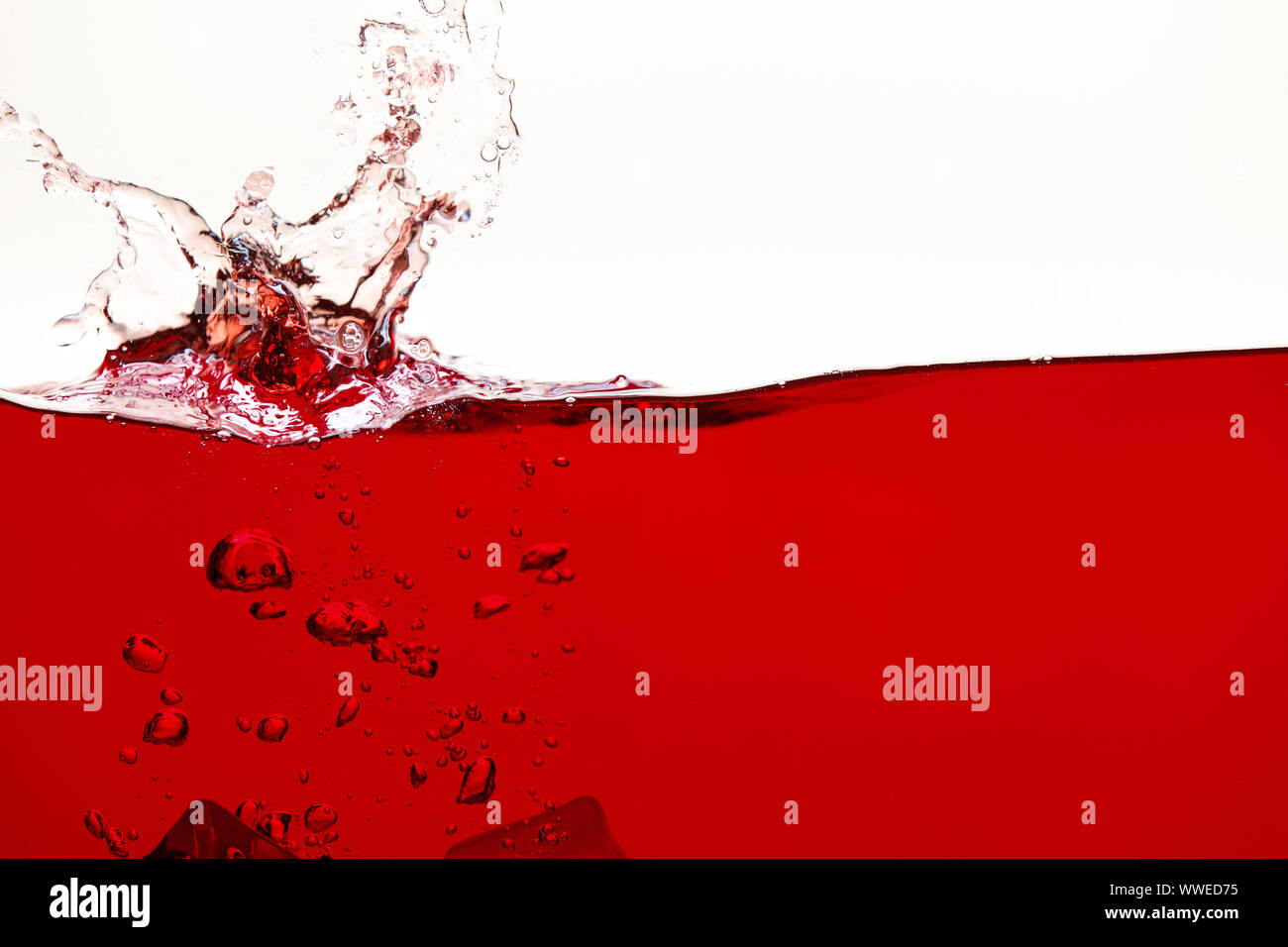 red bright liquid with splash and bubbles isolated on white Stock Photo ...