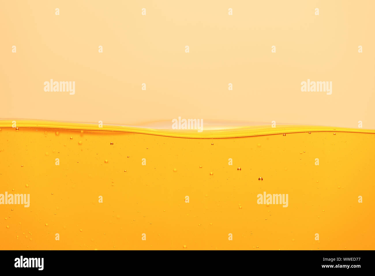 yellow bright liquid with underwater bubbles isolated on yellow Stock ...