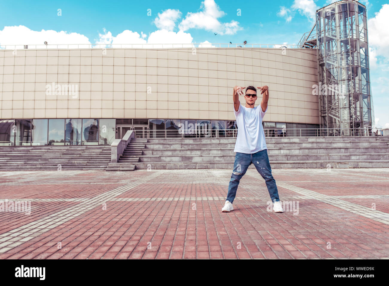 young stylish man standing posing, guy dancer, summer city, dancing ...