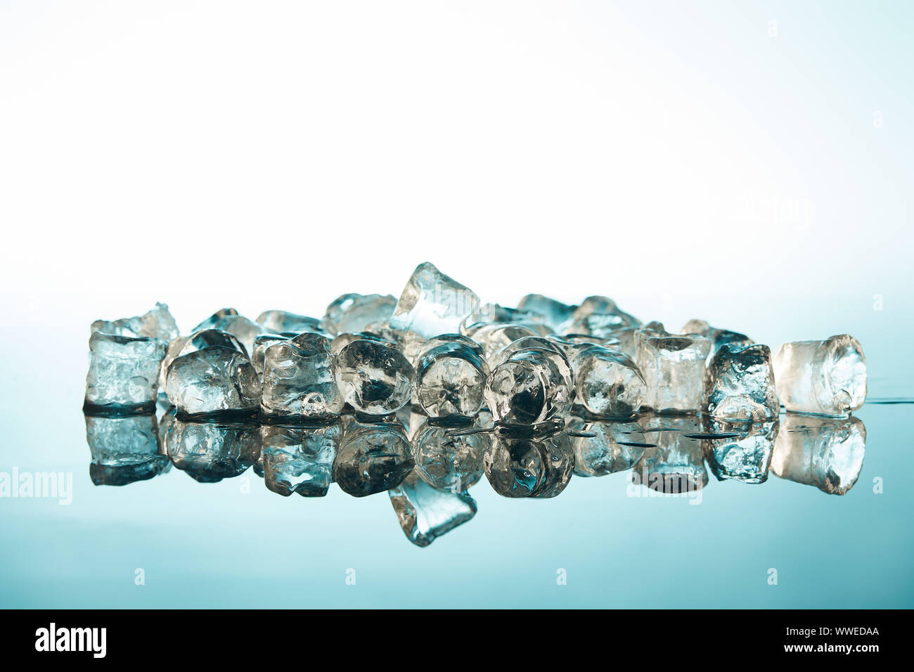 stack of transparent ice cubes on emerald and white background Stock ...