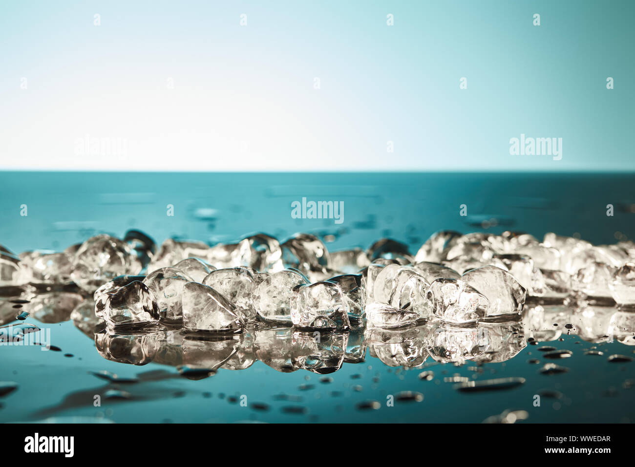 fresh melting ice cubes on emerald and white background Stock Photo - Alamy