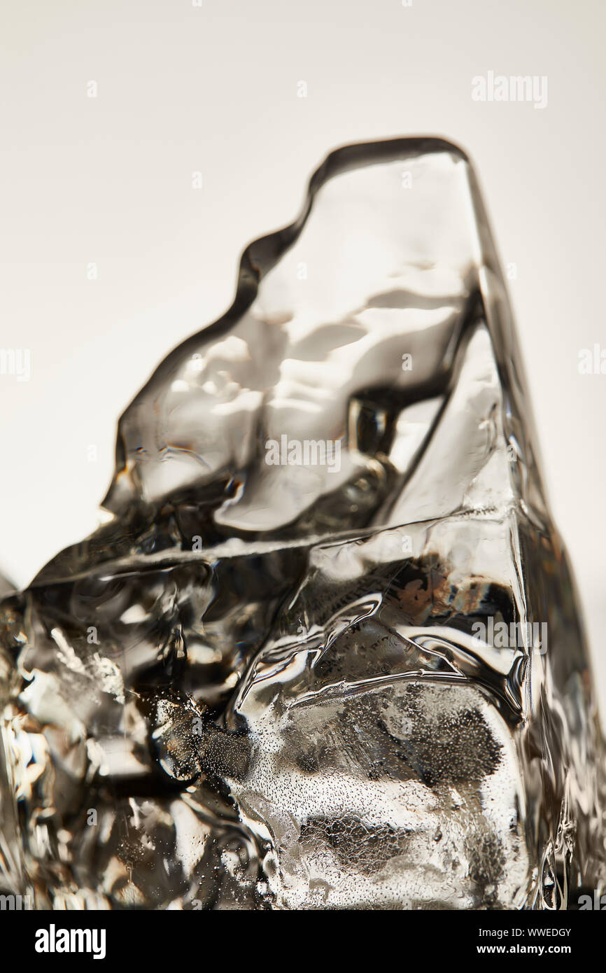 close up view of transparent melting ice cube isolated on grey Stock ...