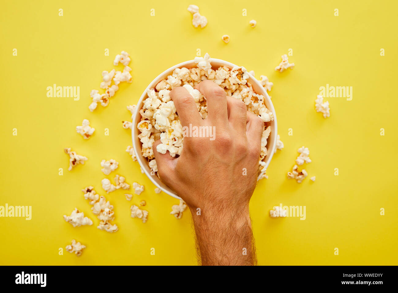 Grabbing popcorn from bucket hi-res stock photography and images - Alamy