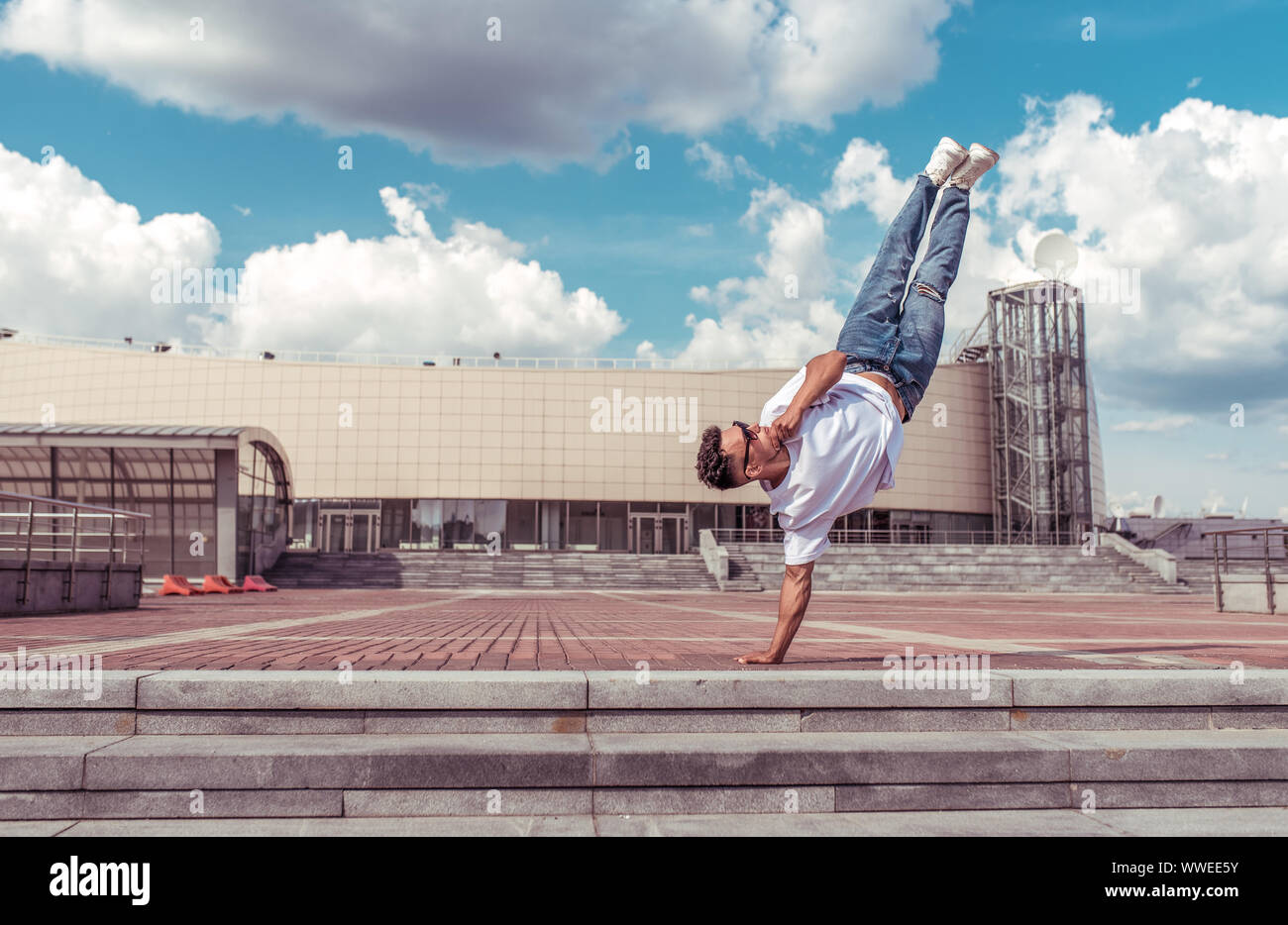 young stylish man standing one arm, guy dancer, summer city, dancing ...