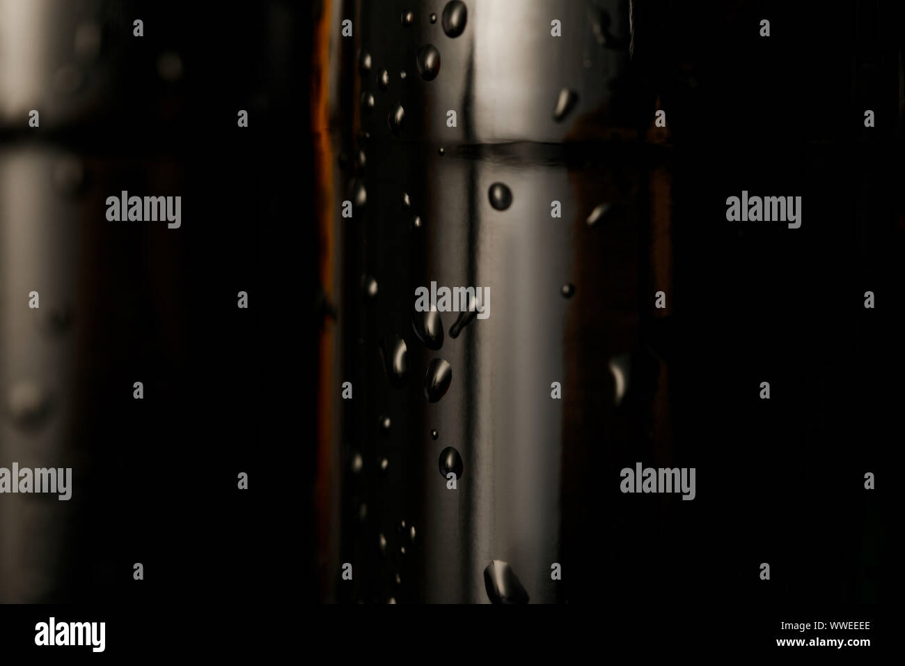 close up view of glass bottle of beer with water drops isolated on ...