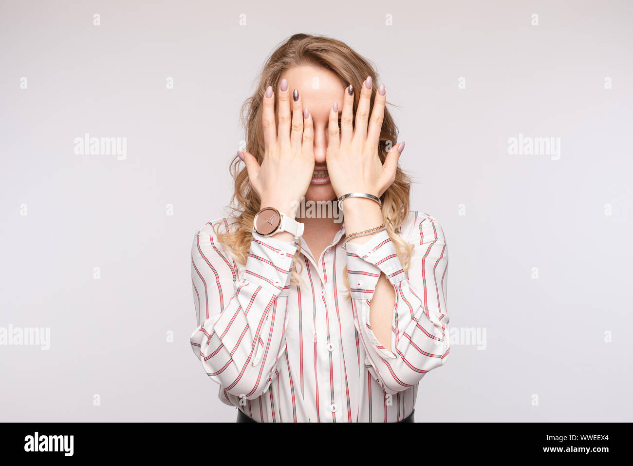 Fashion casual business woman posing closing face by hand isolated at ...