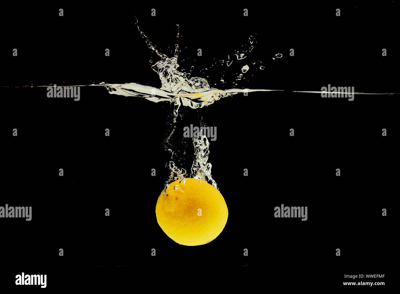 lemon falling deep in water with splash isolated on black Stock Photo ...