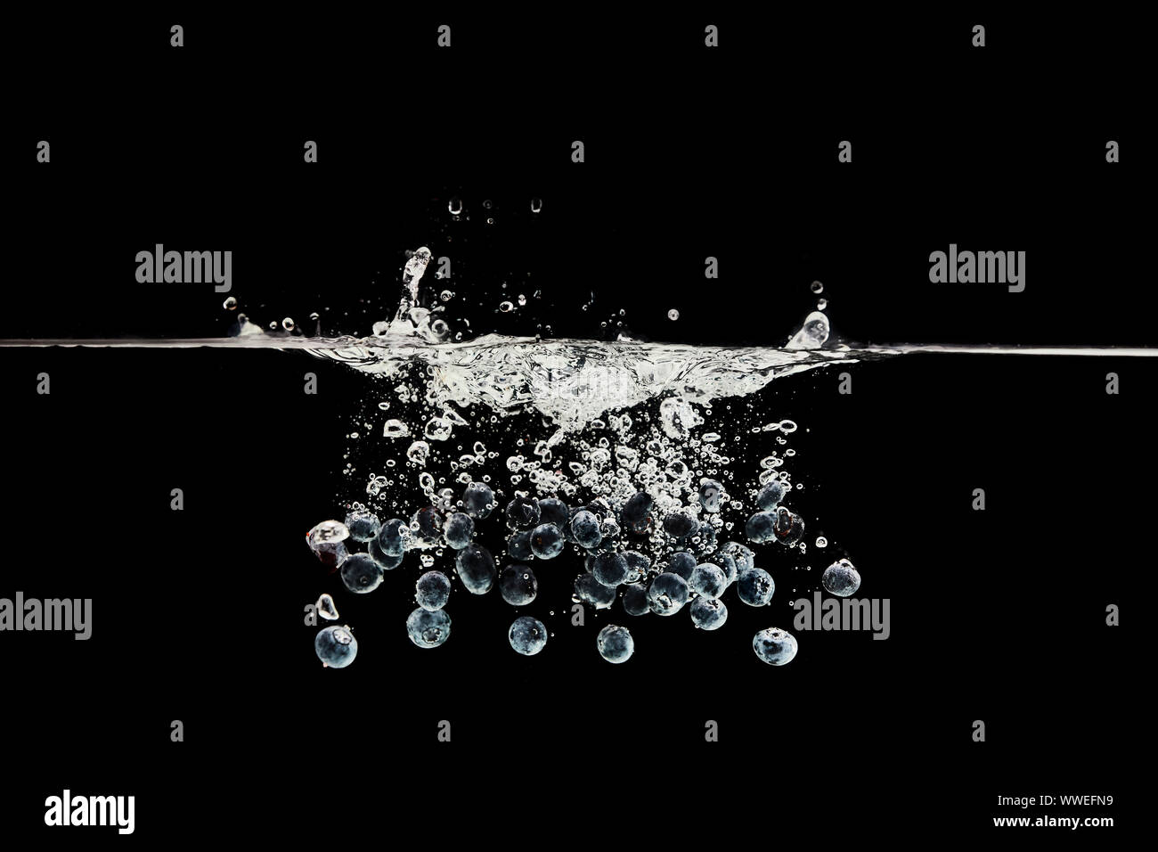 fresh blueberries falling in water with splash isolated on black Stock ...