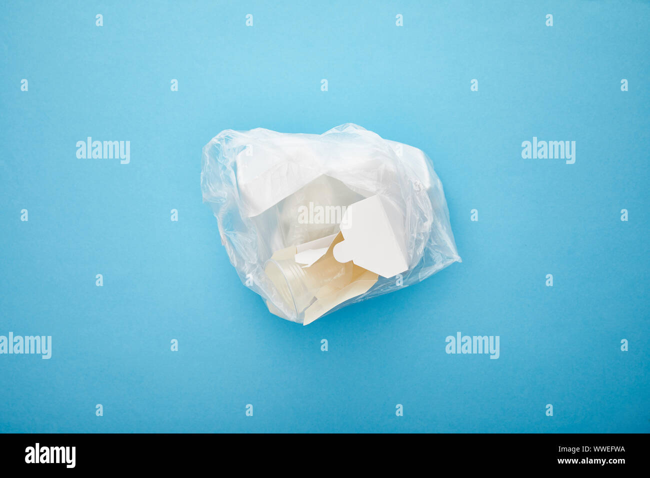top view of plastic bag with disposable cardboard containers on blue ...