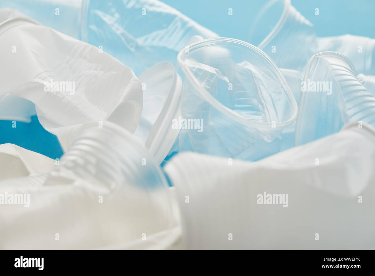 crumpled white and transparent plastic cups on blue background Stock ...