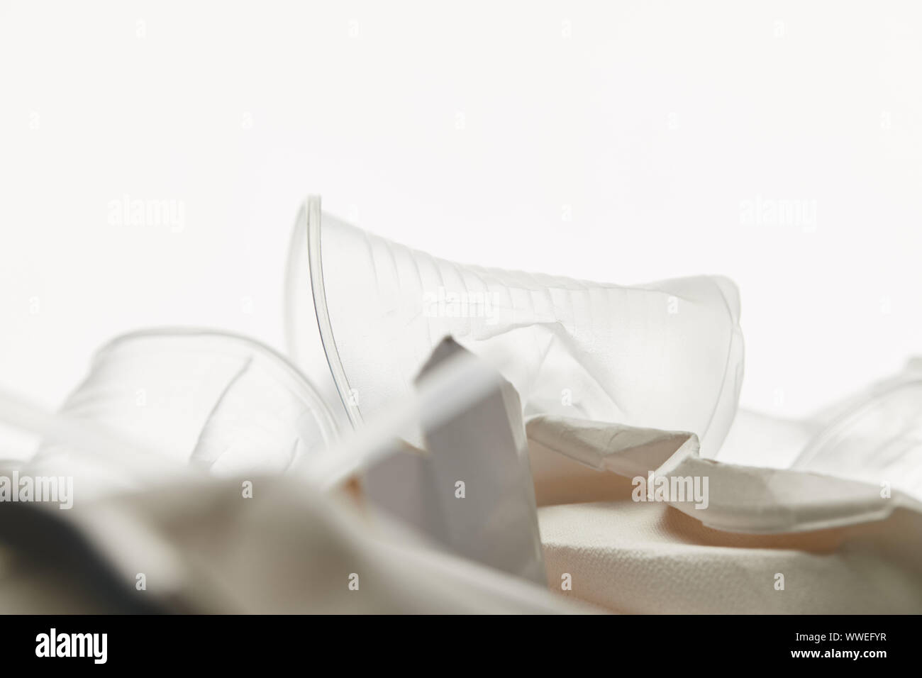 close up view of crumpled transparent plastic cups in pile of rubbish ...