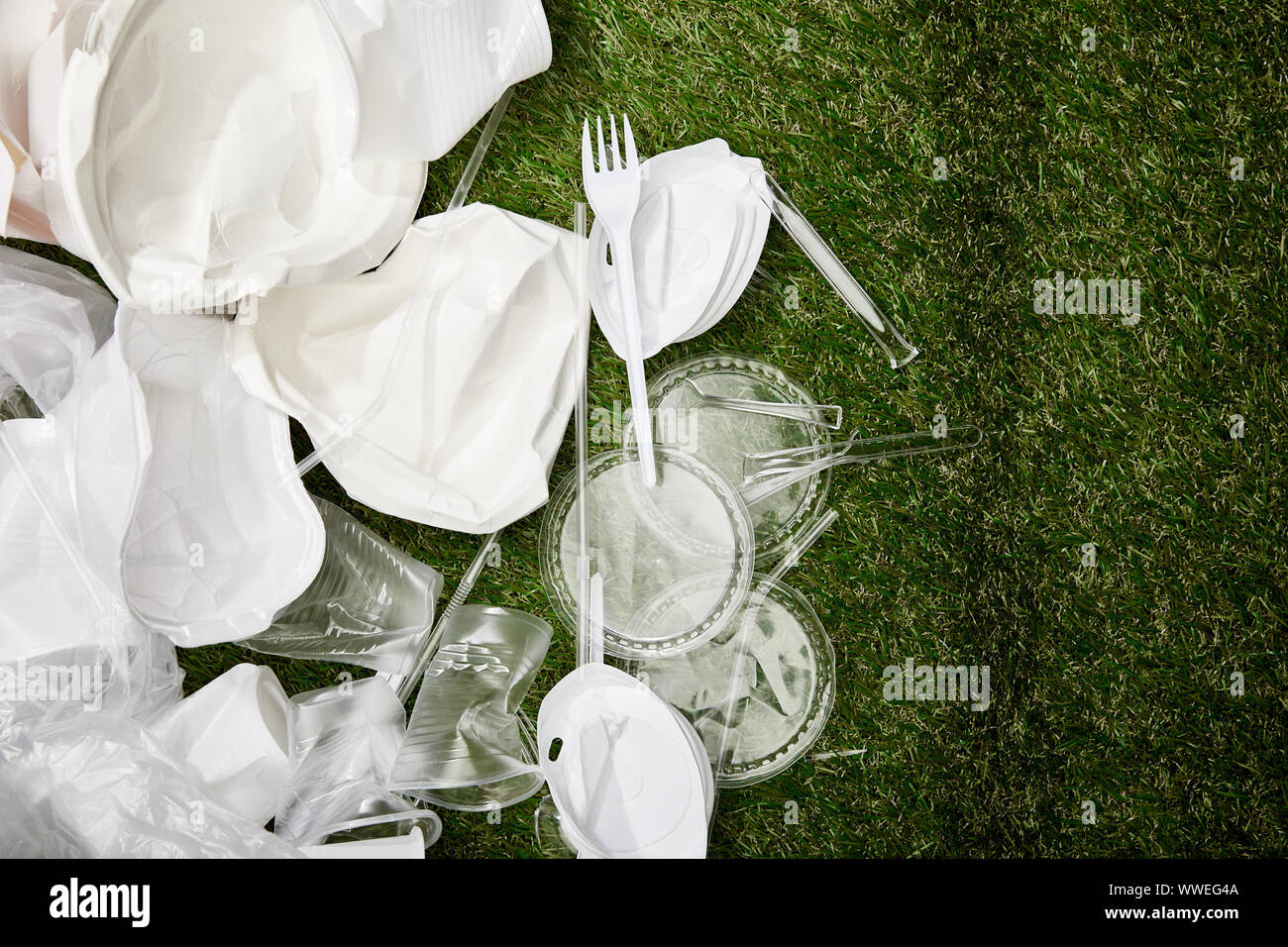 top view of crumpled plastic and cardboard rubbish on grass Stock Photo ...