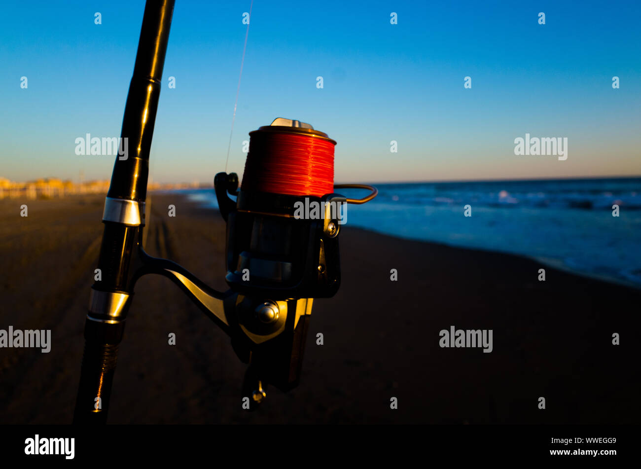 Silhouette of a reel at sunset on a beach, backlight, beautiful blue ...