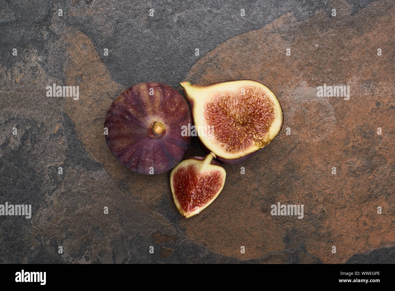 top view of ripe whole and cut figs on stone background Stock Photo - Alamy