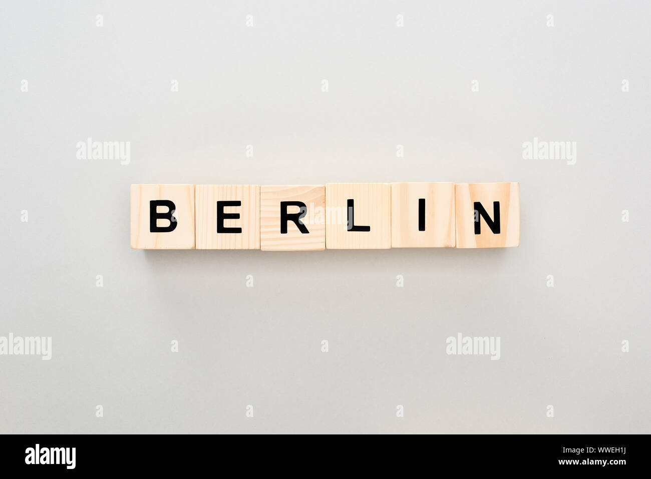 top view of wooden blocks with Berlin lettering on grey background ...