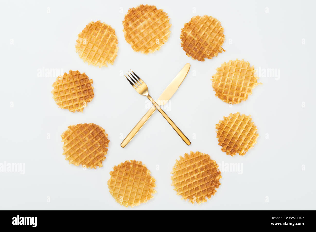 top view of waffles with fork and knife in middle isolated on white ...