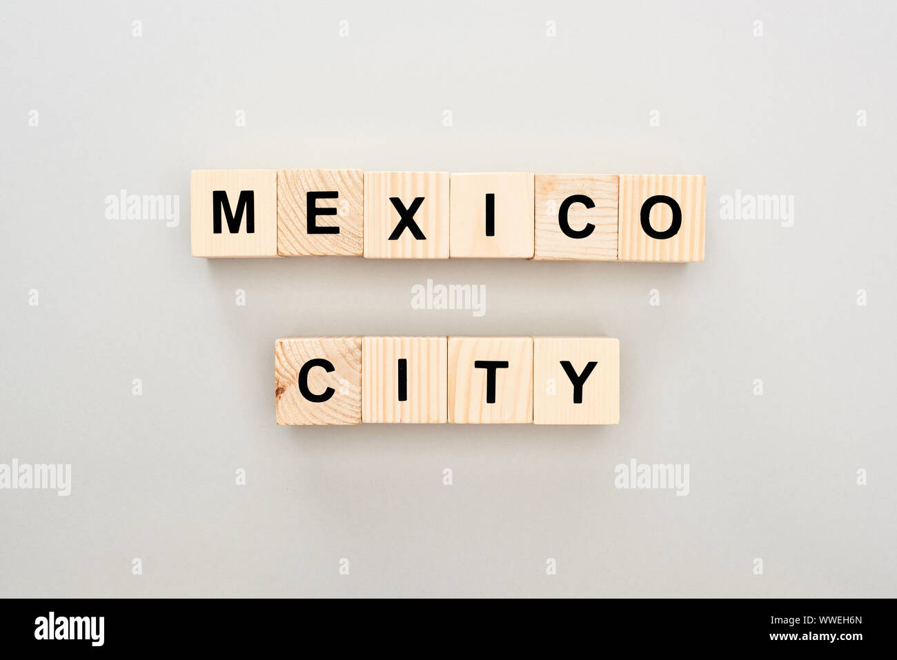 top view of wooden blocks with Mexico City lettering on grey background ...
