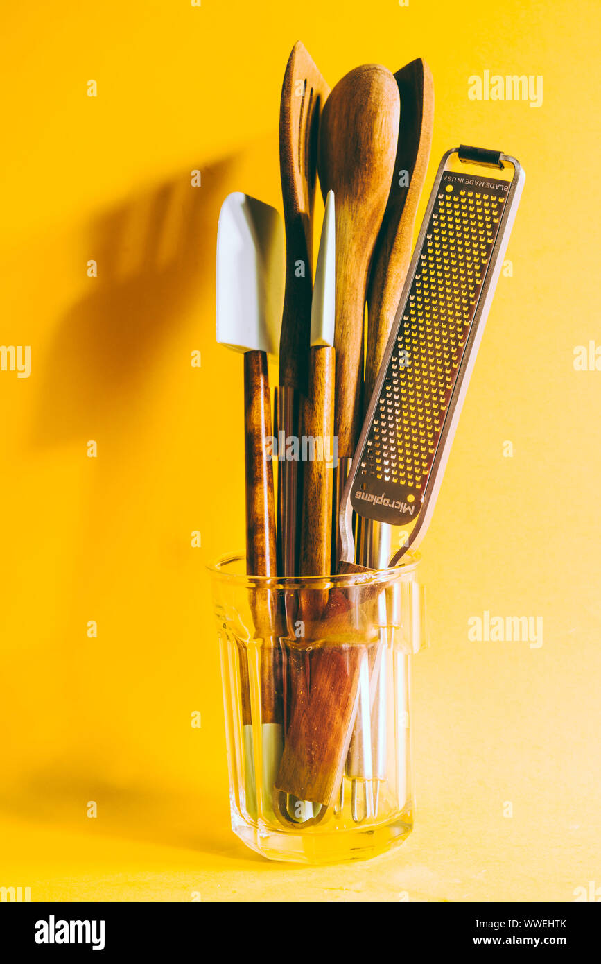 Kitchen foody background, utensil and a white oven container on a brown ...