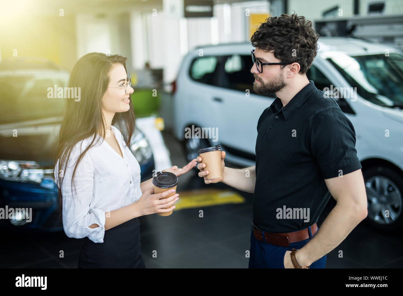 Professional salesperson selling cars at dealership to buyer Stock ...