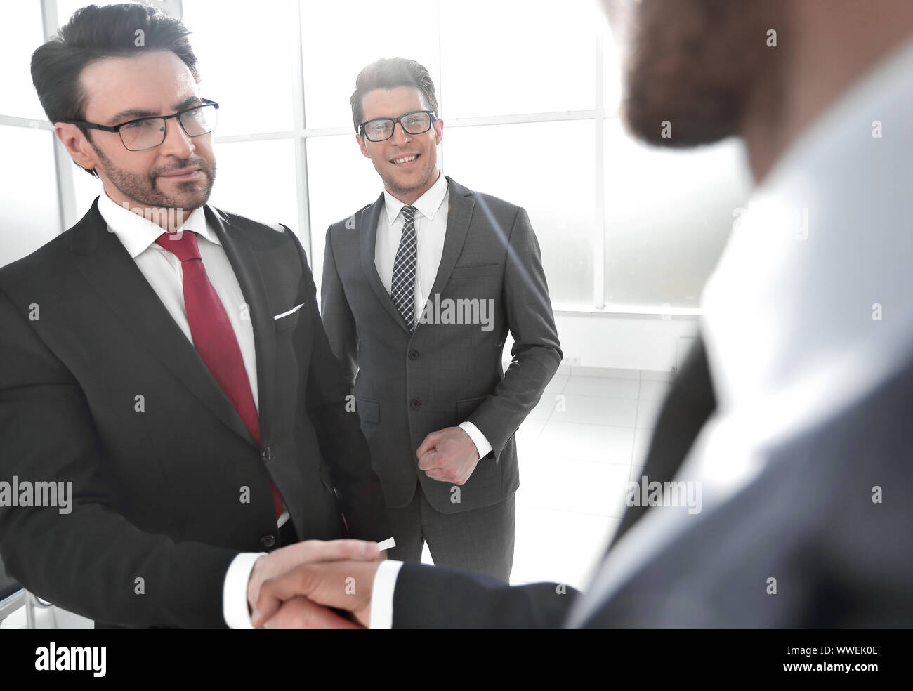 Manager shaking the hand of the customer Stock Photo - Alamy
