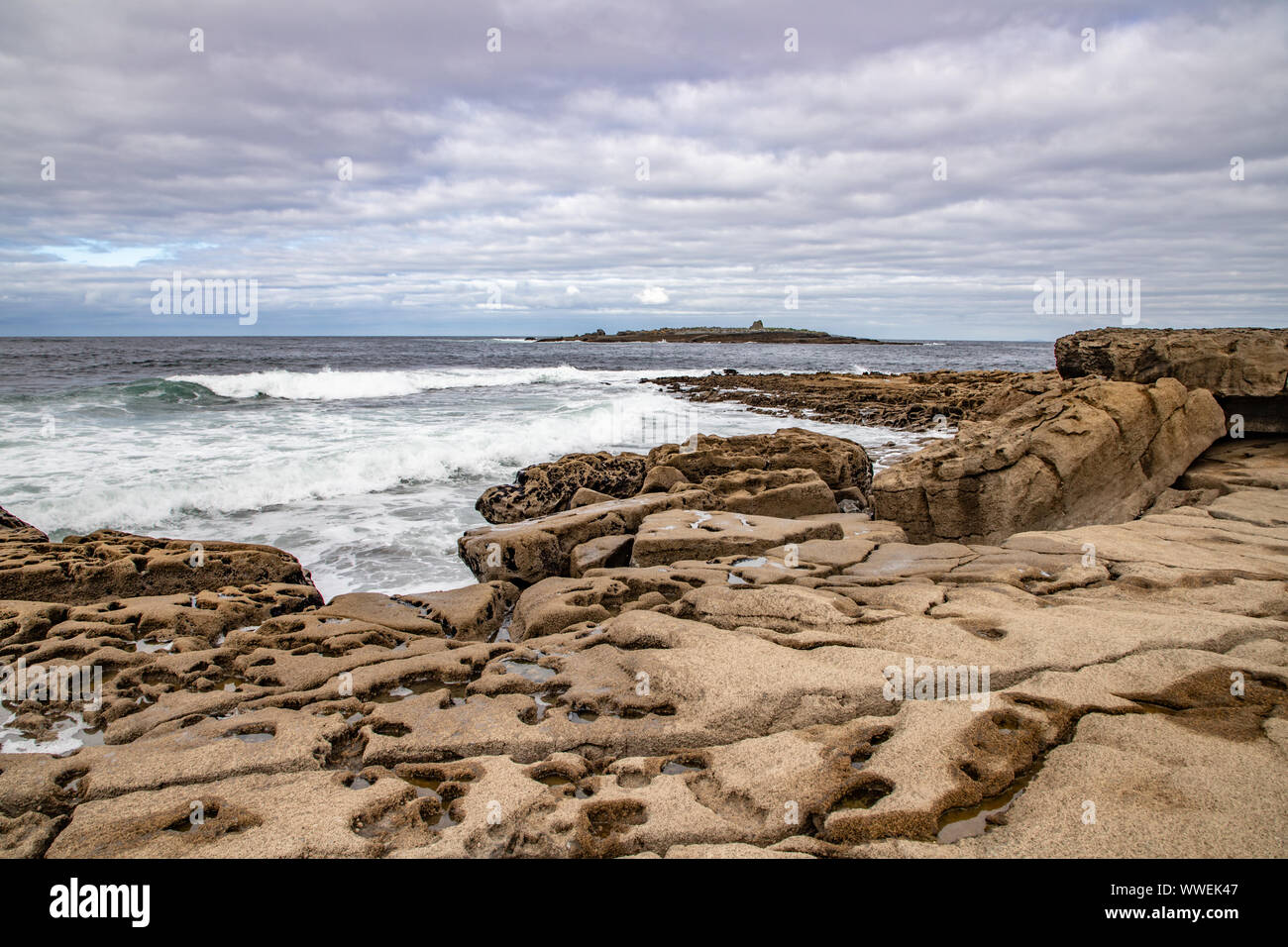 Harbour beach with waves and Crab Island in background, Doolin, Clare ...