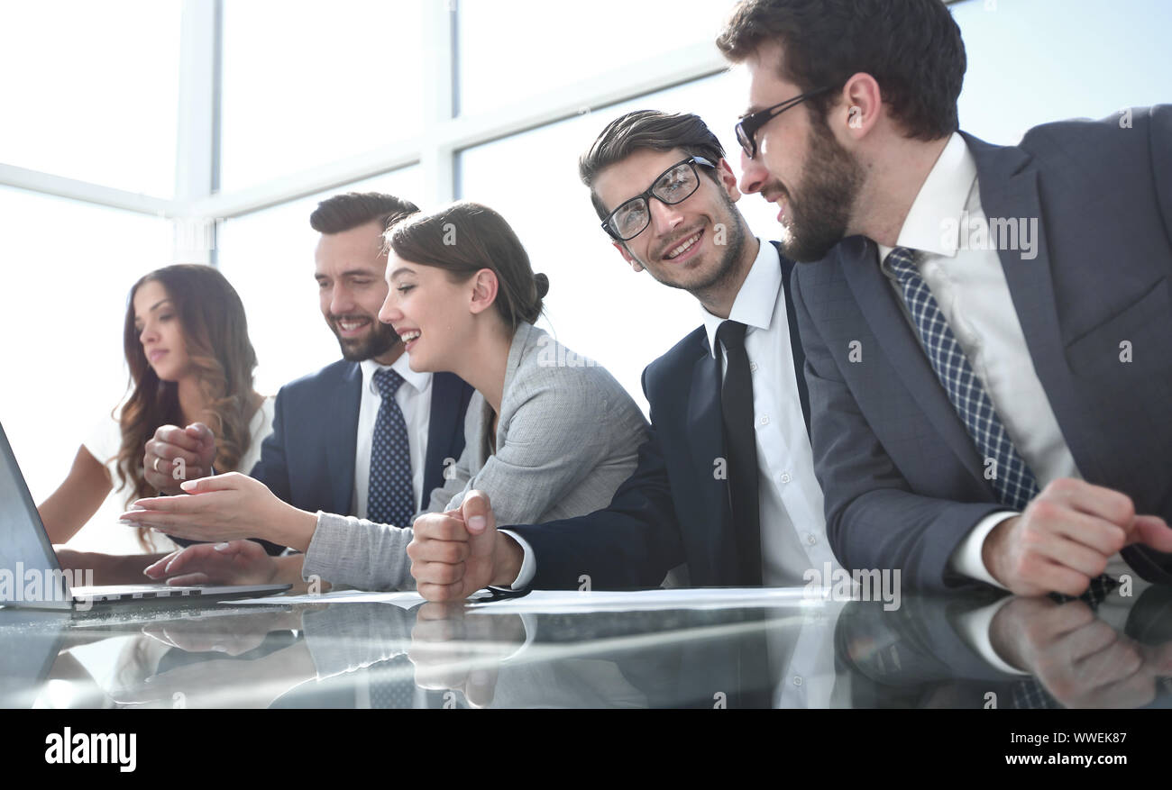 business team sitting at the office Desk in the office Stock Photo - Alamy