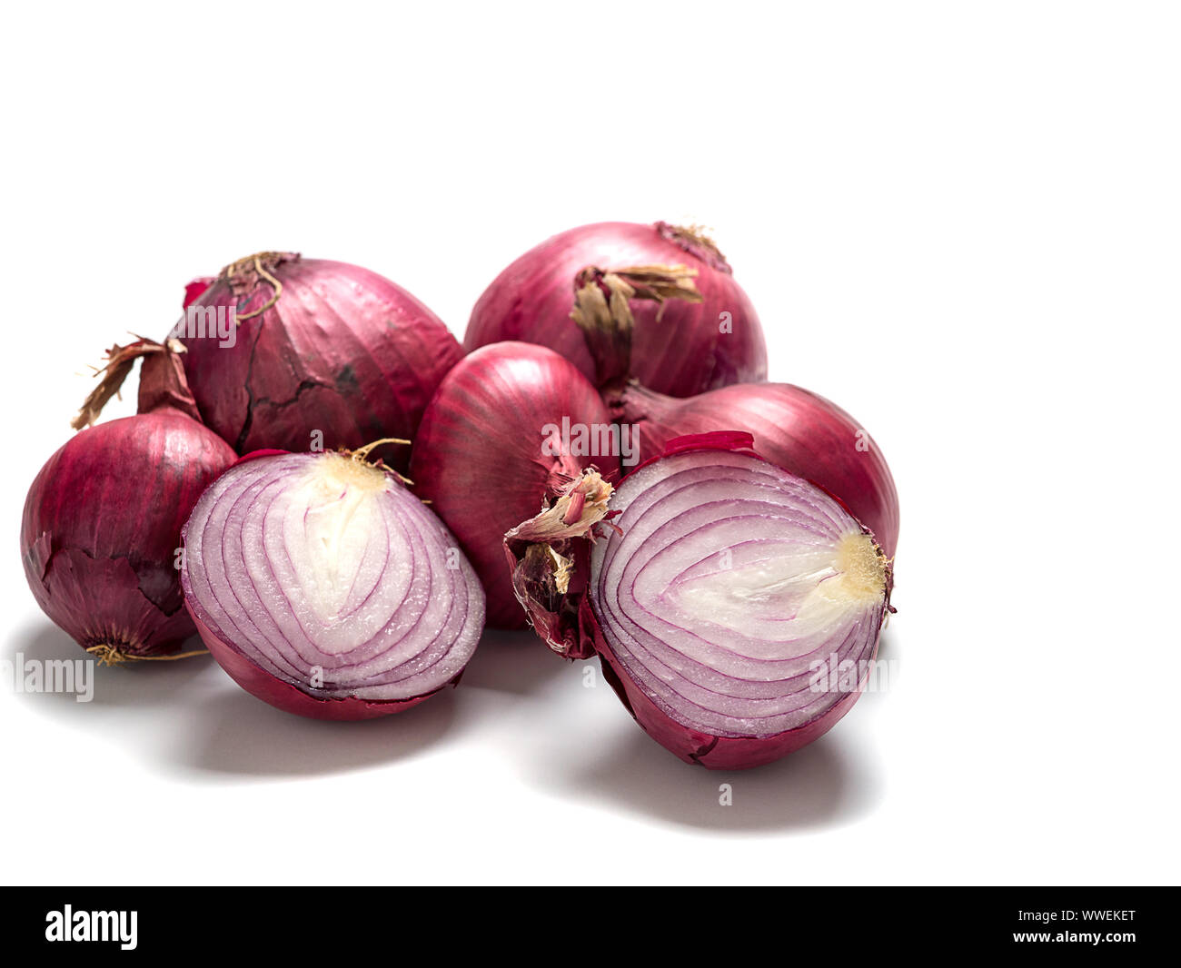 Six red onions, one sliced, isolated on white background. Selective ...