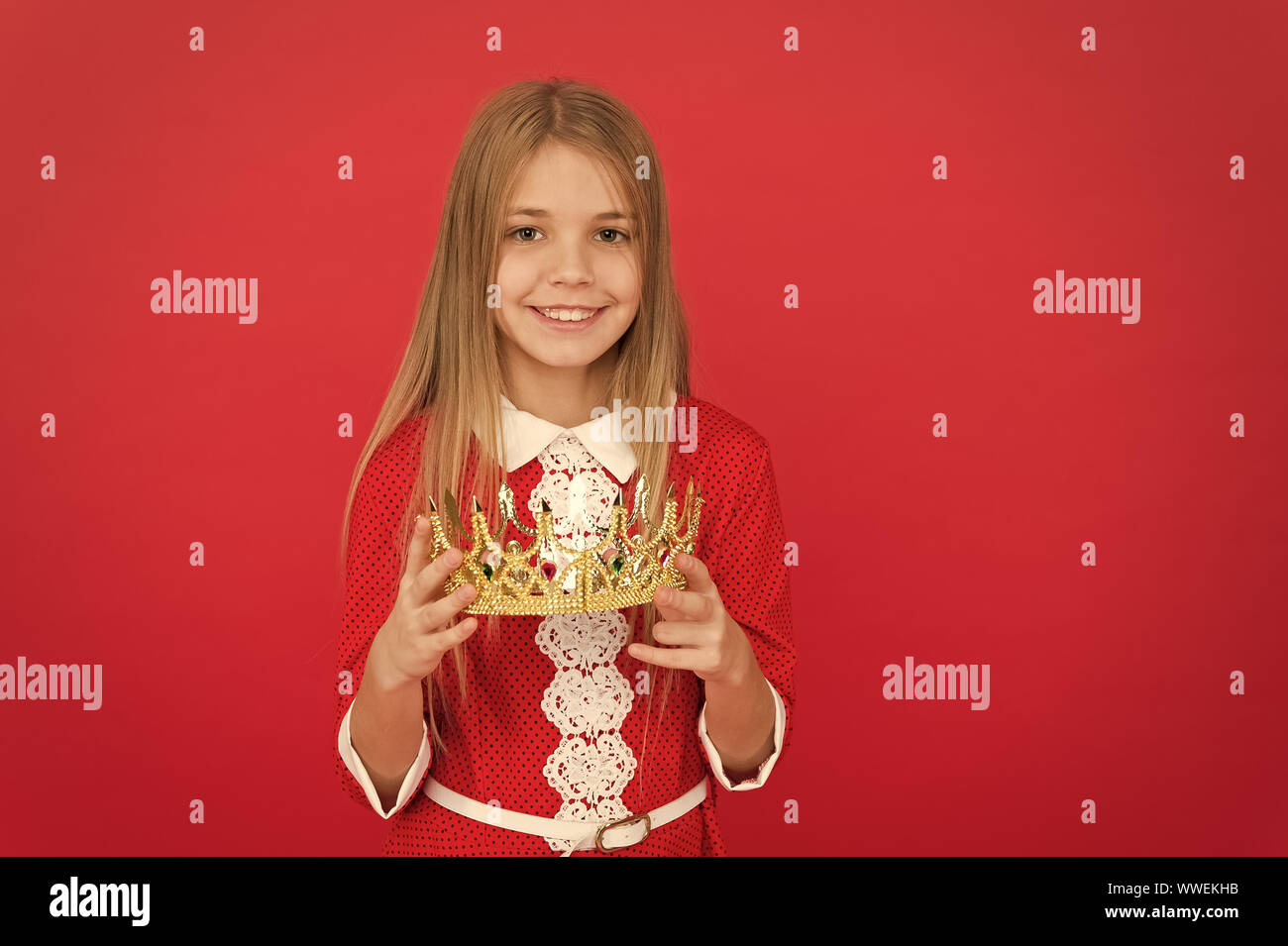 Lady little princess. Girl cute smile hold crown while stand red ...