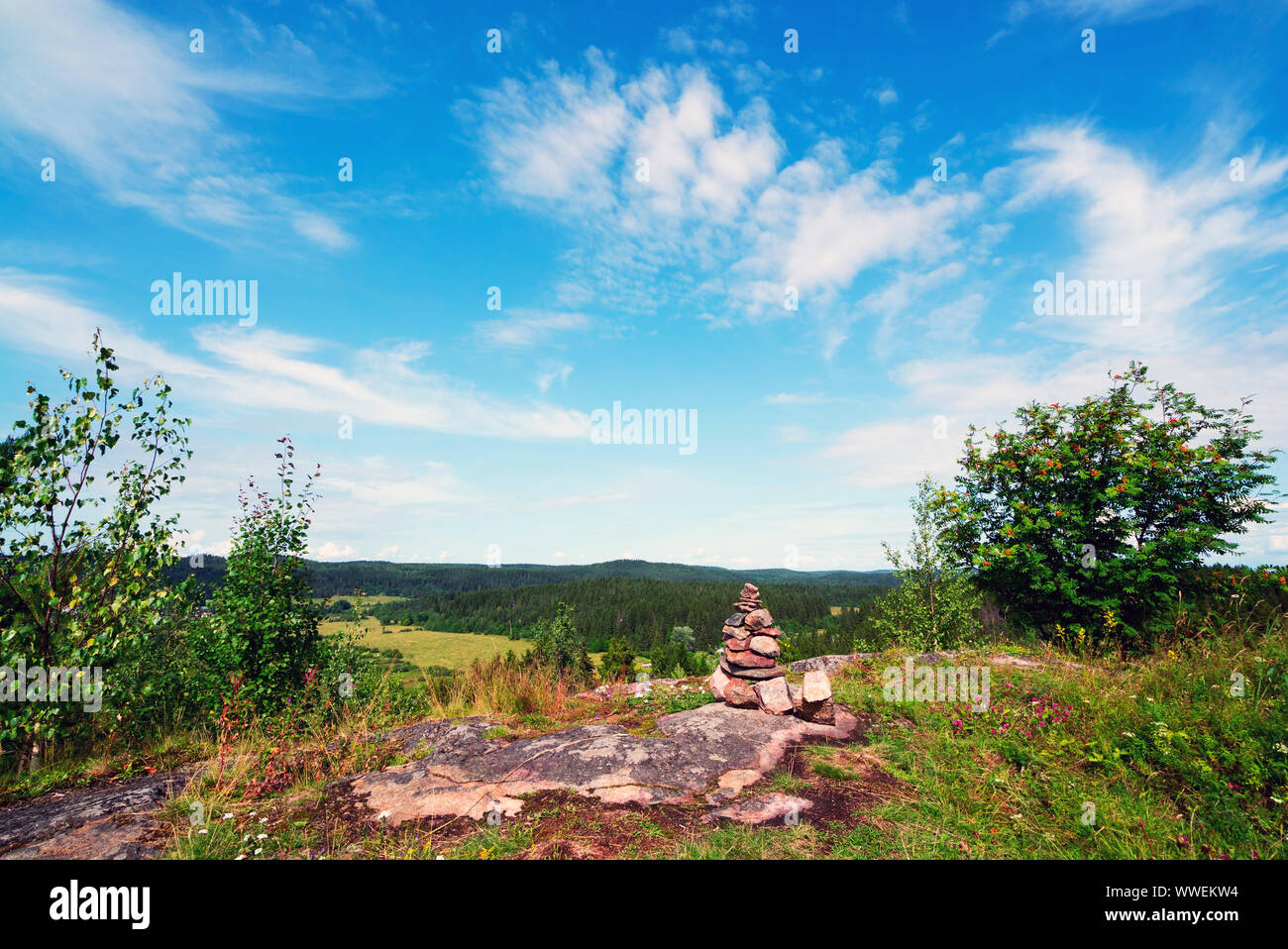 A small stone pyramid on the cliff . Summer landscape, Karelia Stock ...