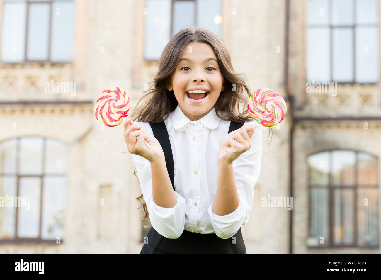 Sugar addiction. Cheat meal day. Happy kid with sweet candy. Kid child ...