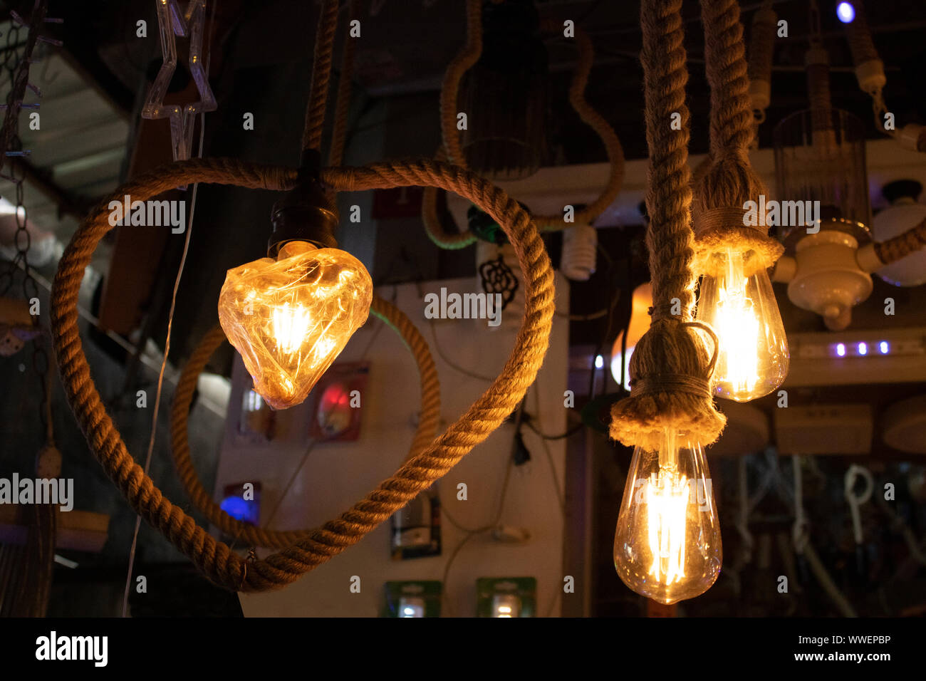 Lamps hanging on rope, brown rope and yellow light Stock Photo - Alamy
