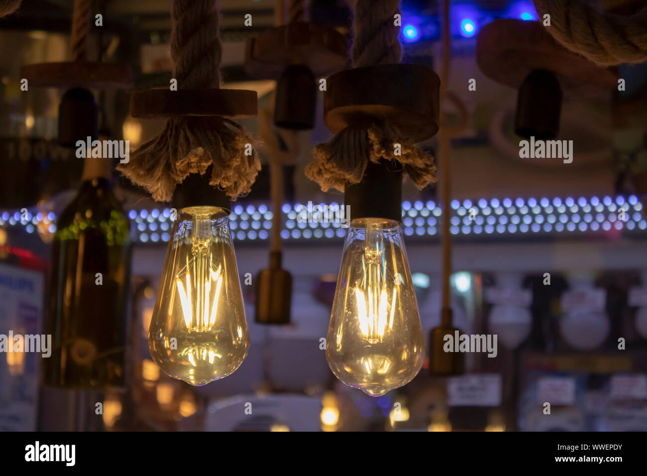 Lamps hanging on rope, brown rope and yellow light Stock Photo - Alamy