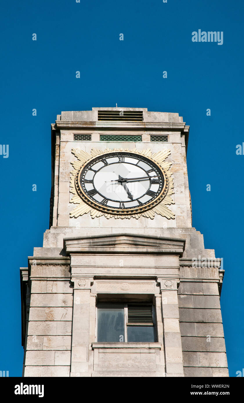 Clock face on the Cocker Clock Tower set against a deep blue sky in ...