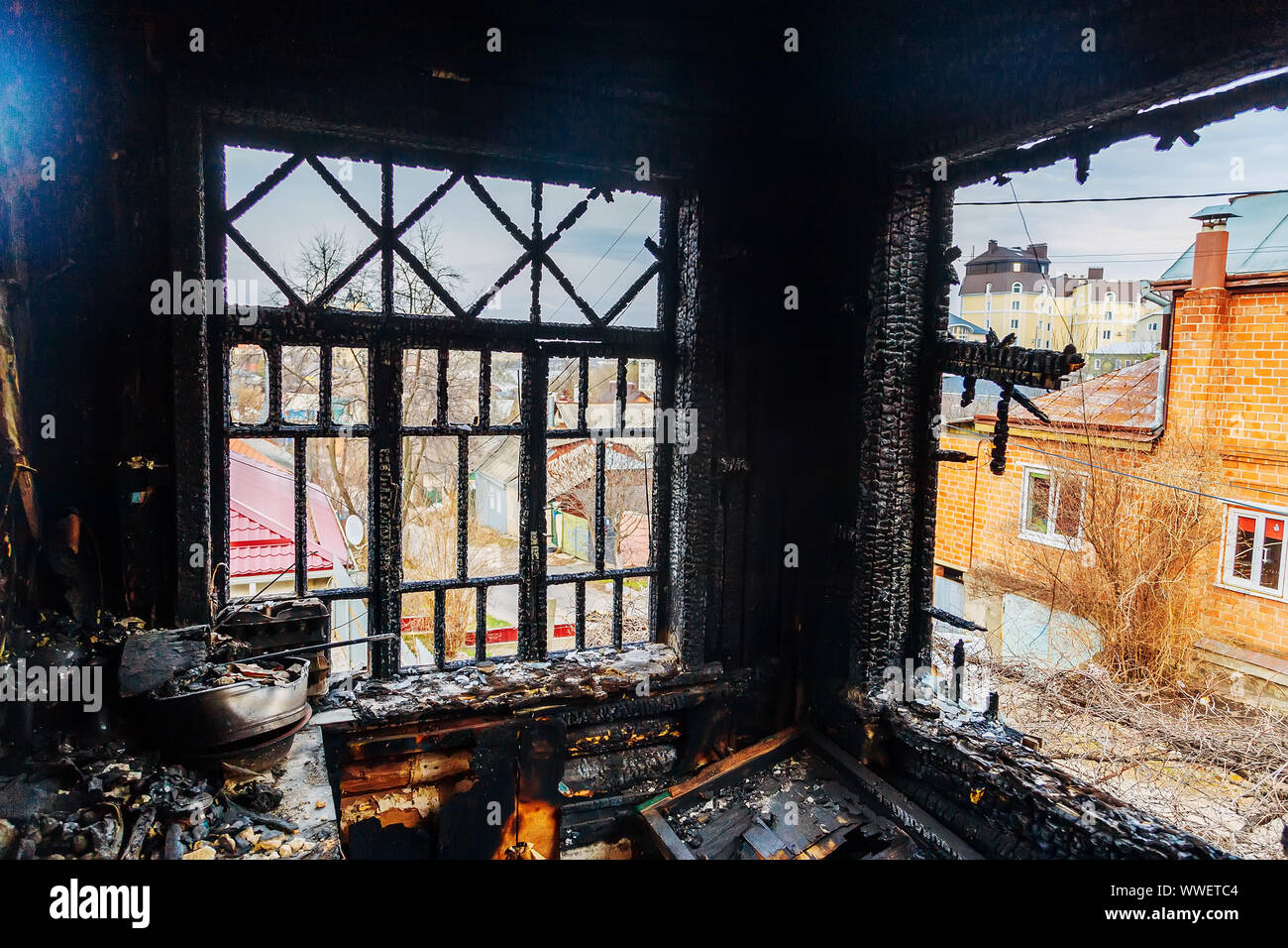 Burnt house interior. Burned kitchen, remains of furniture in black ...
