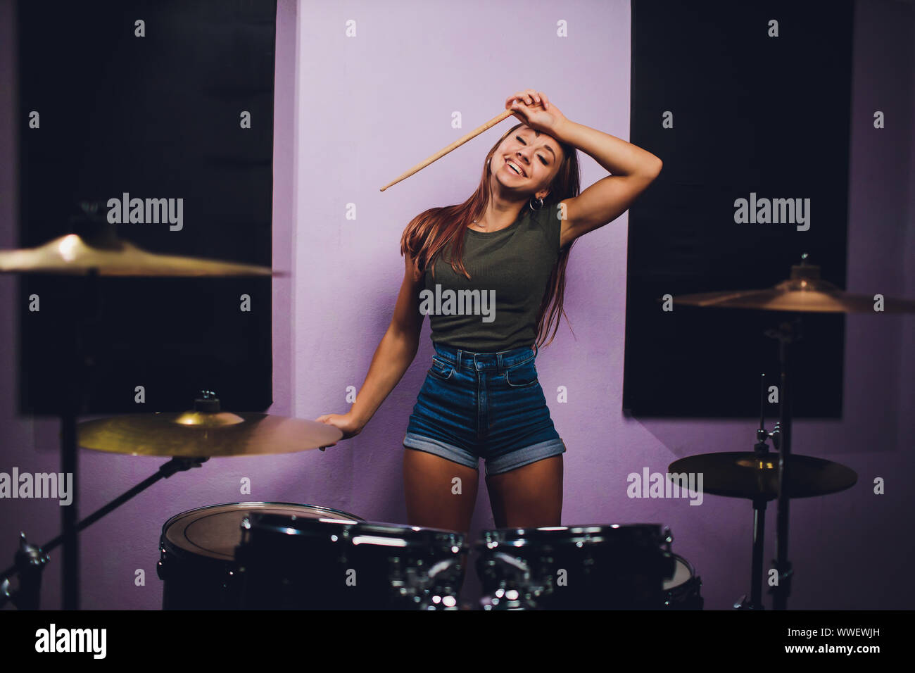 Photograph of a female drummer playing a drum set on stage Stock Photo ...