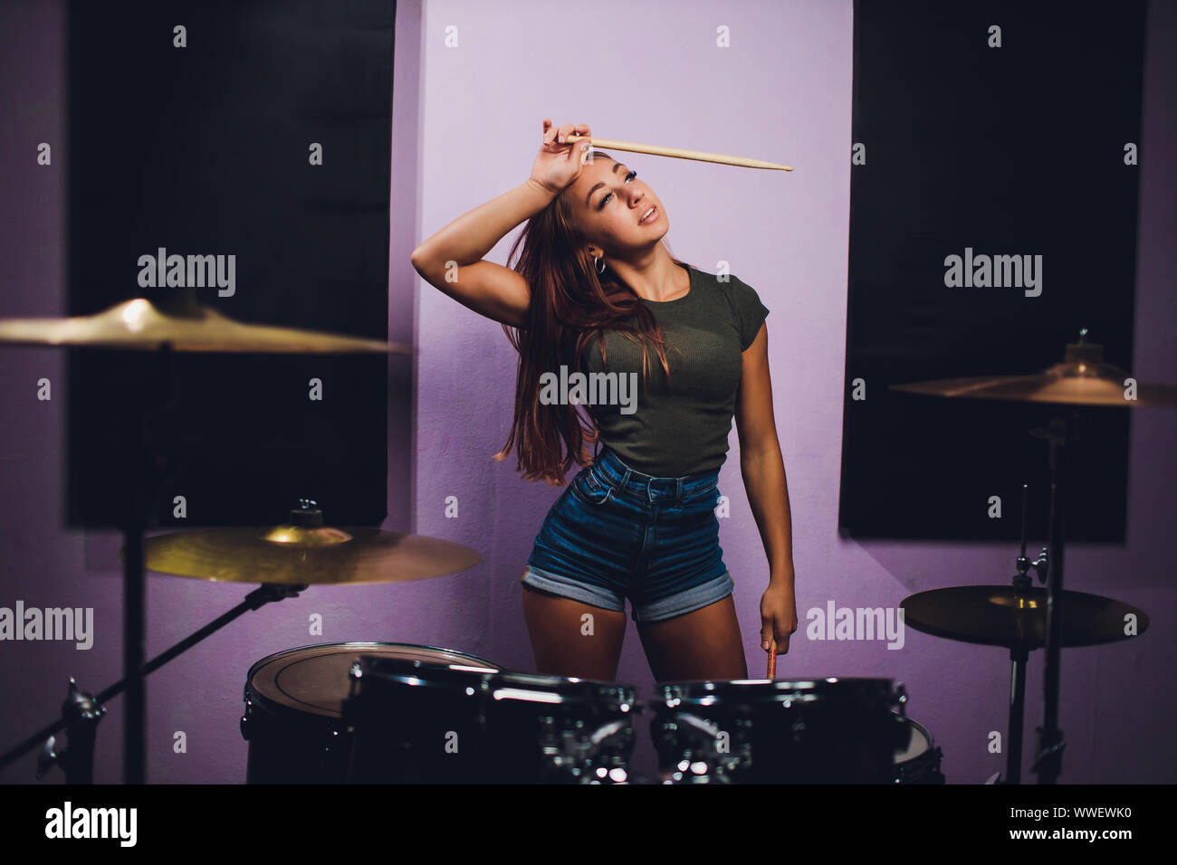 Photograph of a female drummer playing a drum set on stage Stock Photo ...