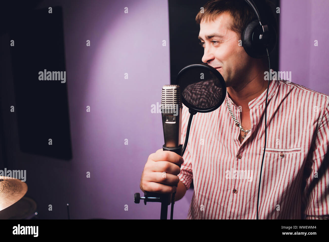 music, show business, people and voice concept - male singer with ...