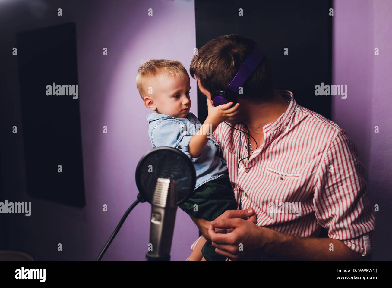 music, show business, people and voice concept - male singer with ...