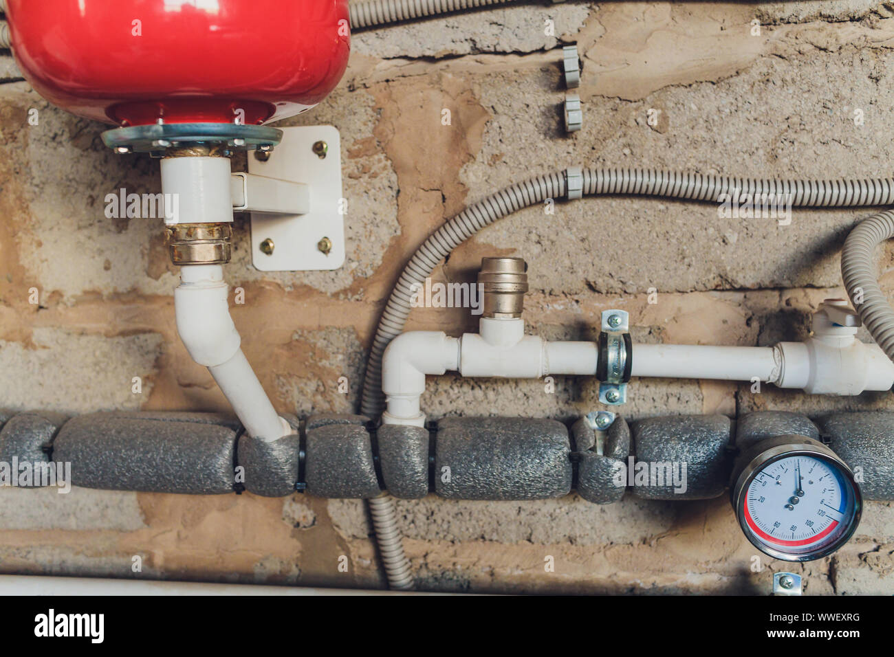 Closeup of manometer, pipes and faucet valves of heating system in a ...
