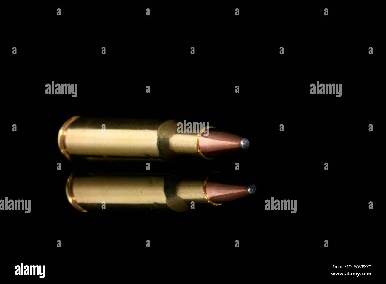 Single 222 Caliber rifle bullet on black background with reflection ...