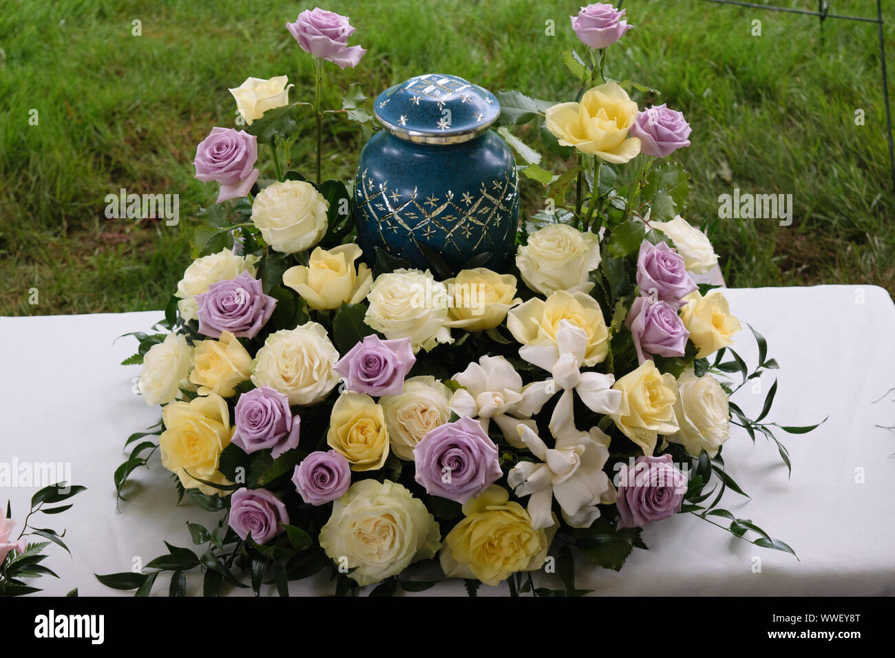 funeral and mourning concept - flowers surrounding urn Stock Photo - Alamy