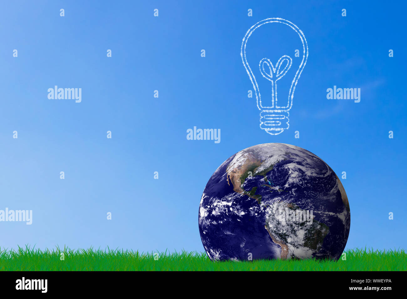 Green energy concept, the earth and light bulb on grass background ...