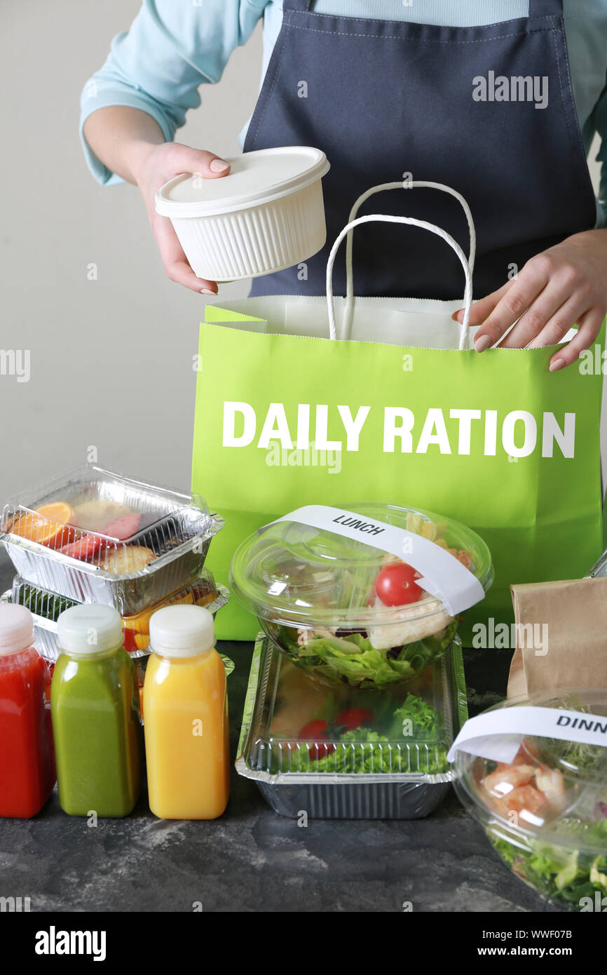 Worker of food delivery service packing order for customer Stock Photo ...