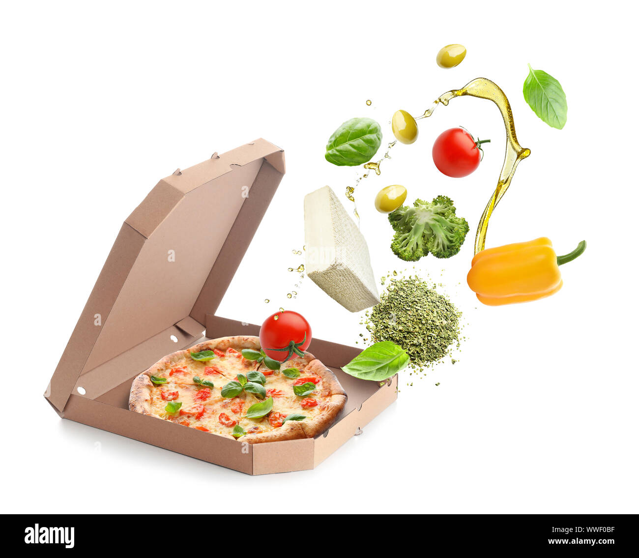 Tasty pizza in box with falling ingredients on white background Stock ...