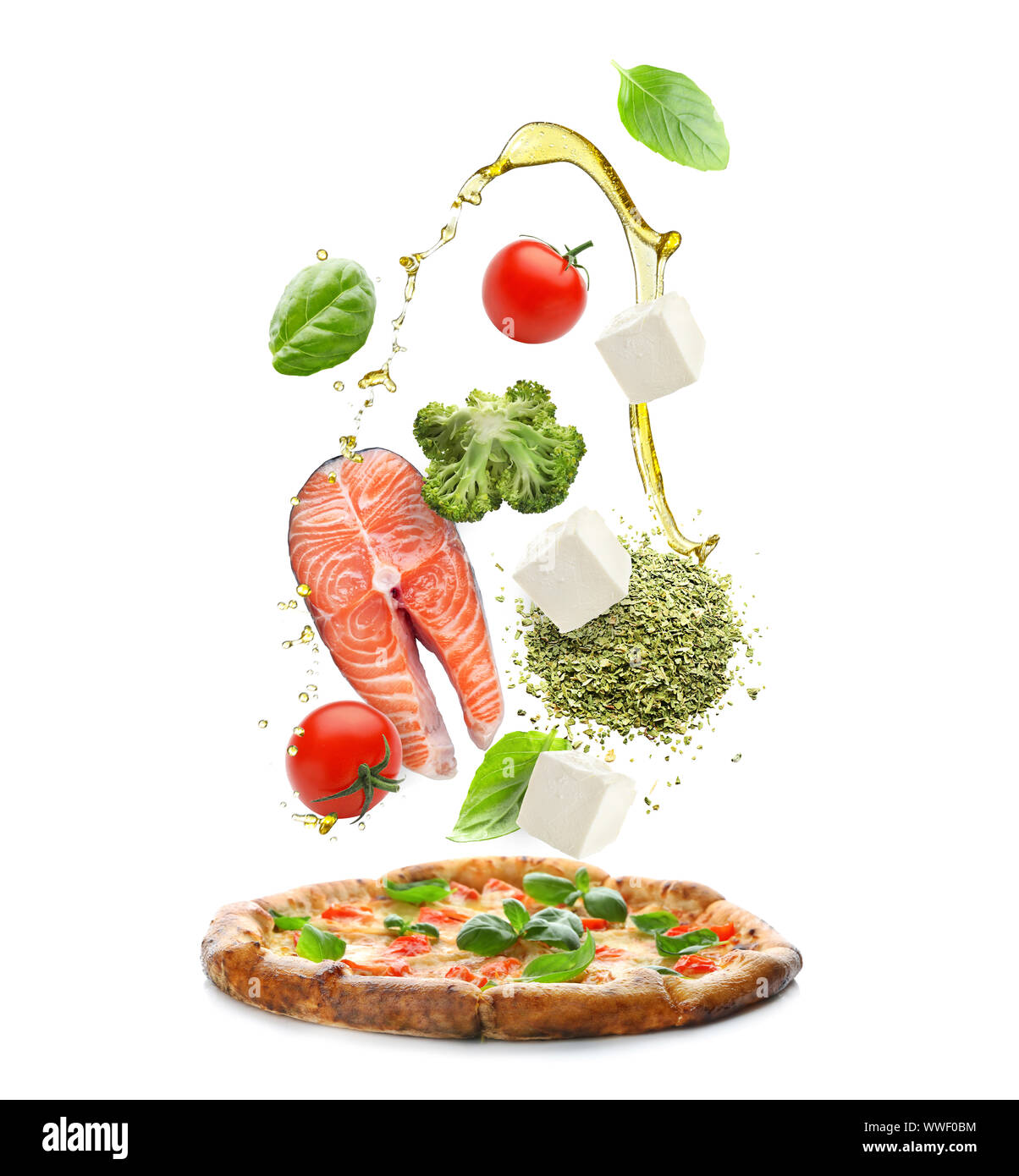 Tasty pizza with falling ingredients on white background Stock Photo ...