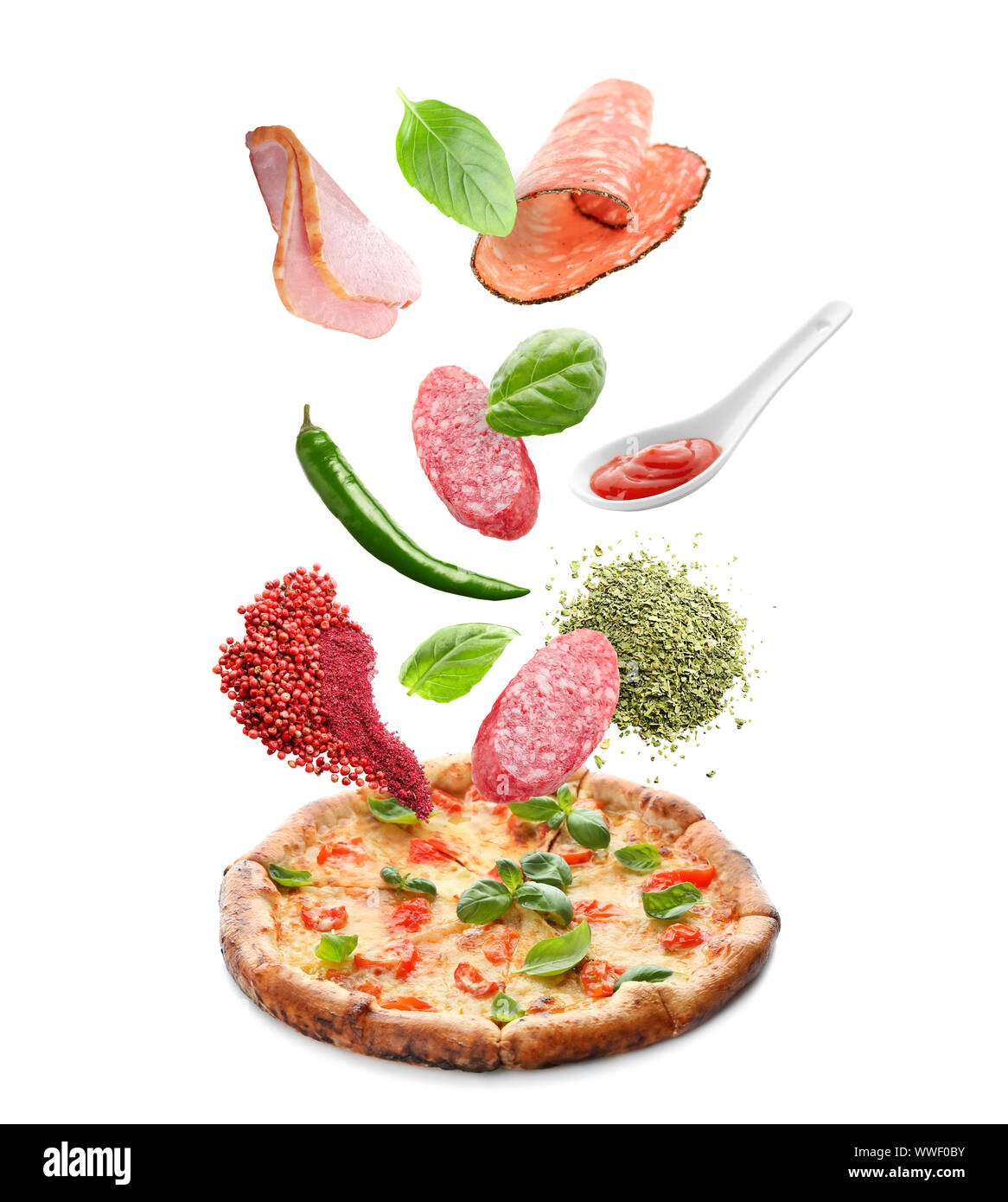 Tasty pizza with falling ingredients on white background Stock Photo ...