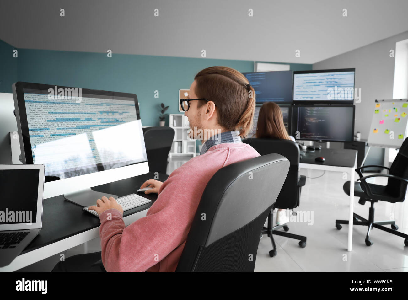 Male programmer working in office Stock Photo - Alamy