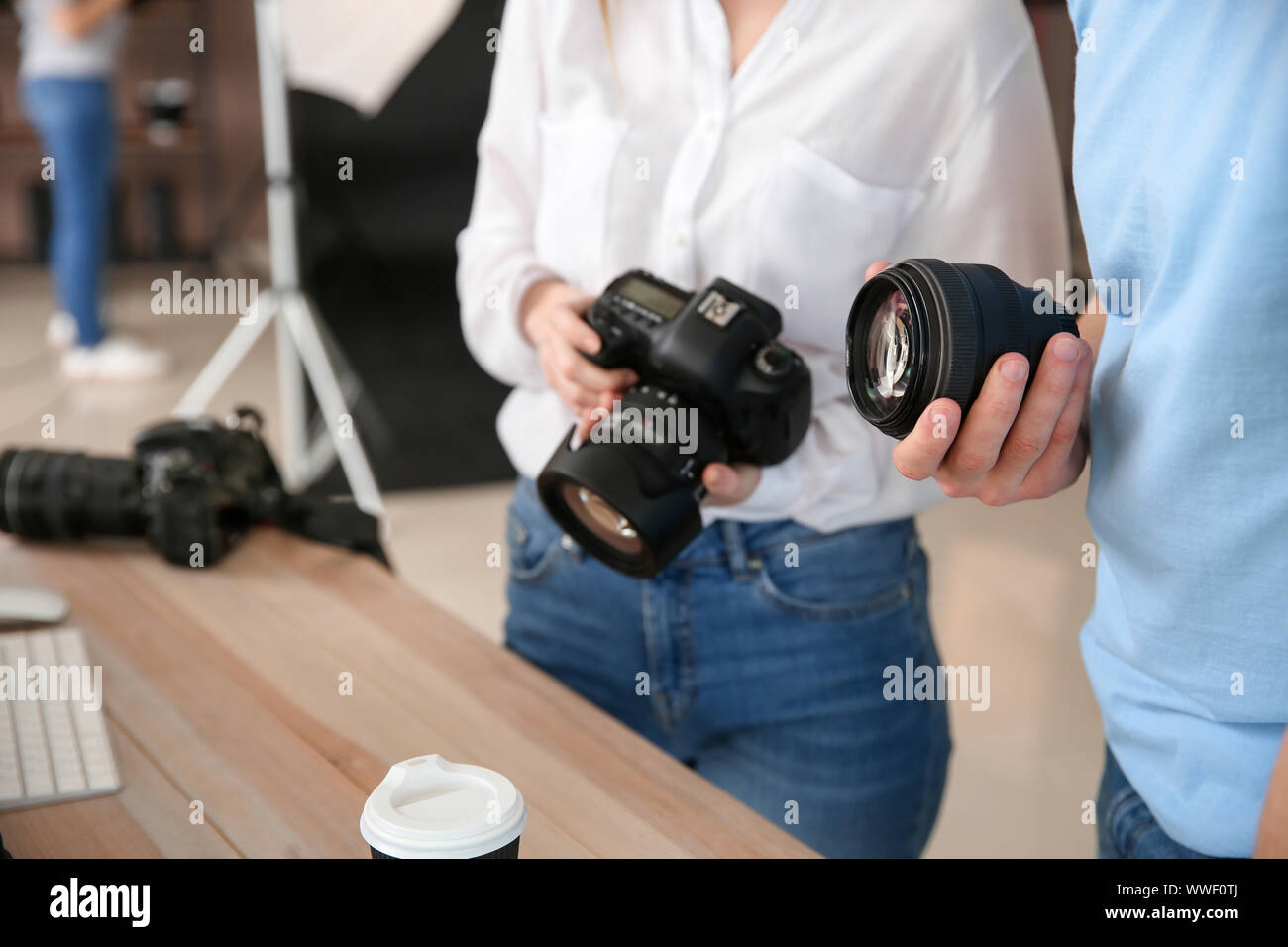 Professional photographers in modern studio Stock Photo - Alamy
