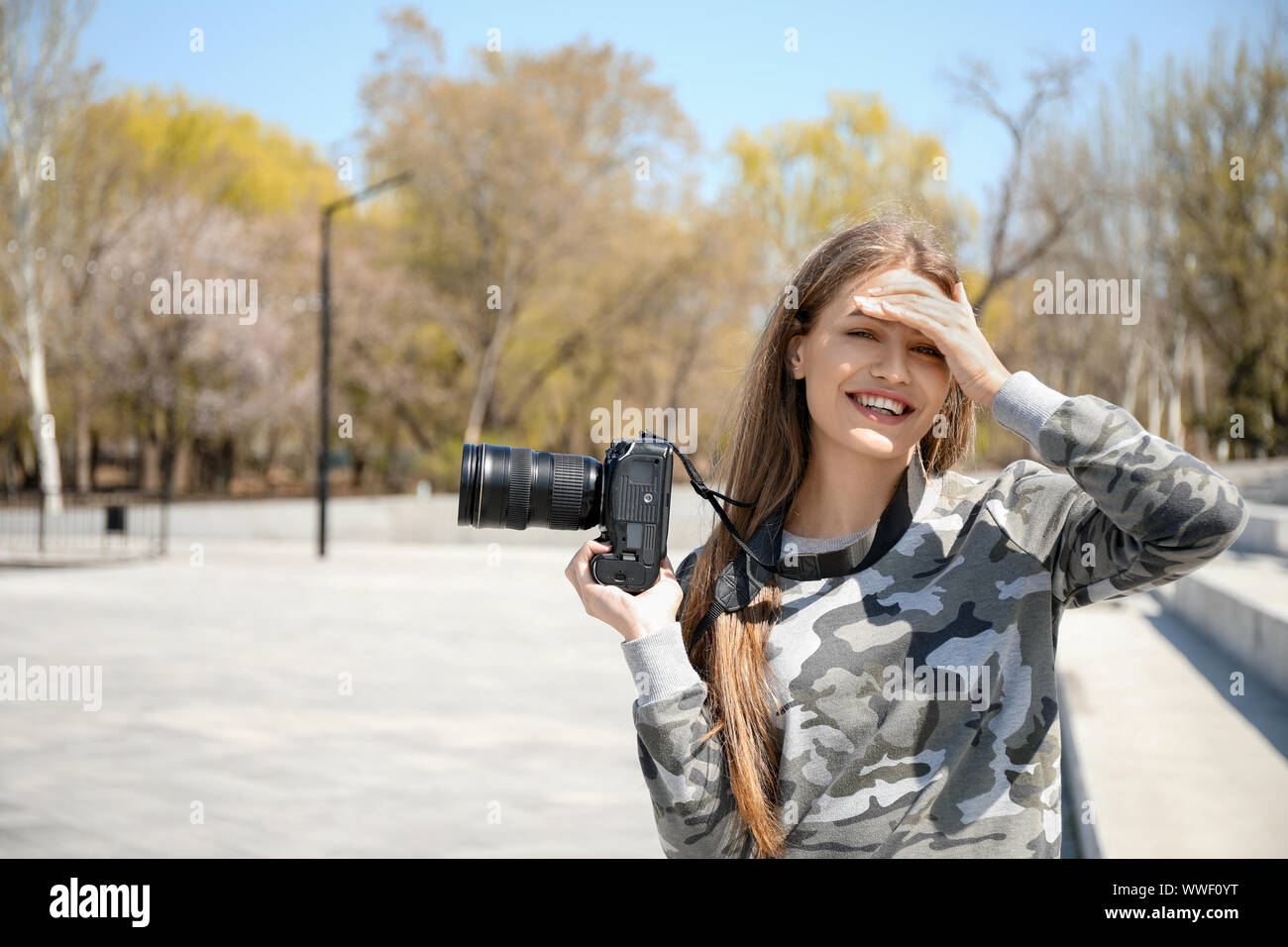 Beautiful female photographer outdoors Stock Photo - Alamy